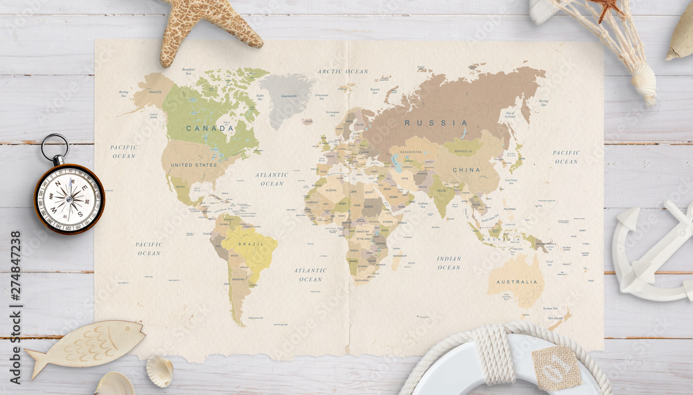 World map on a table surrounded by shells, compass, anchor and lifebelt ...