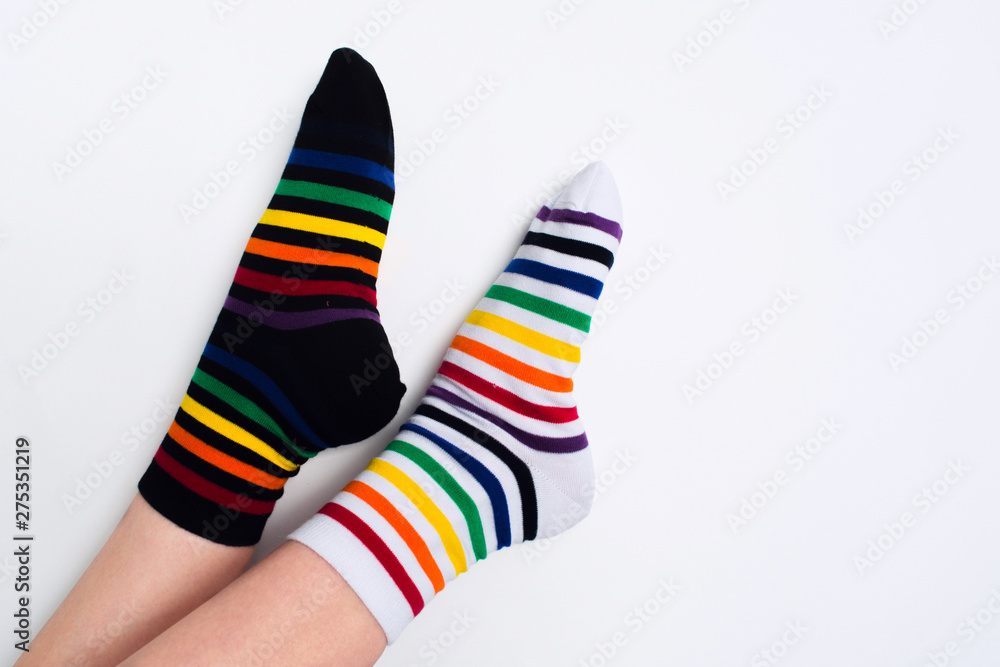 Woman legs wearing funny bright different striped colorful socks on ...