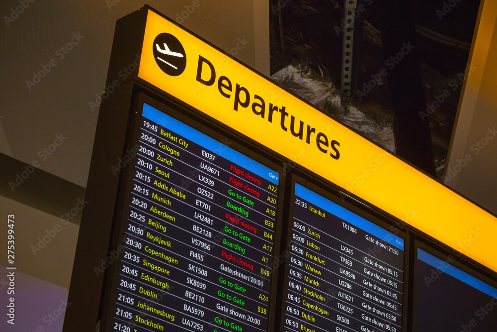 Departure board displaying flight information at London Heathrow airport Stock Photo | Adobe Stock