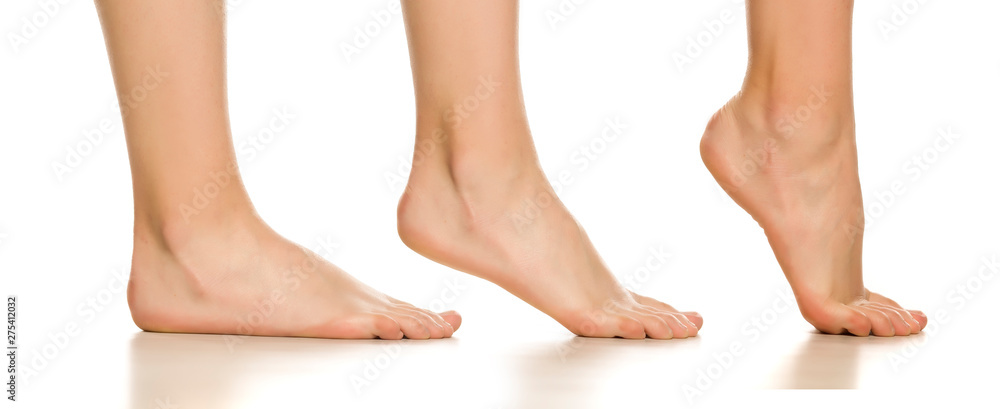 Side view of female bare foot in three different positions on white ...