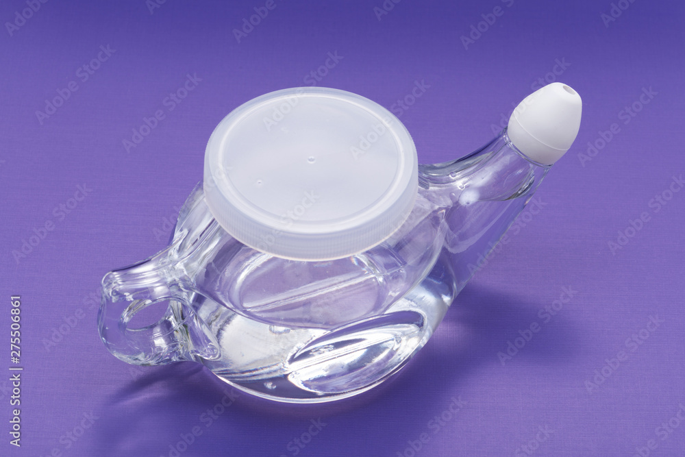 Neti Pot with Soft Comfort Tip isolated on purple background. Sinus ...