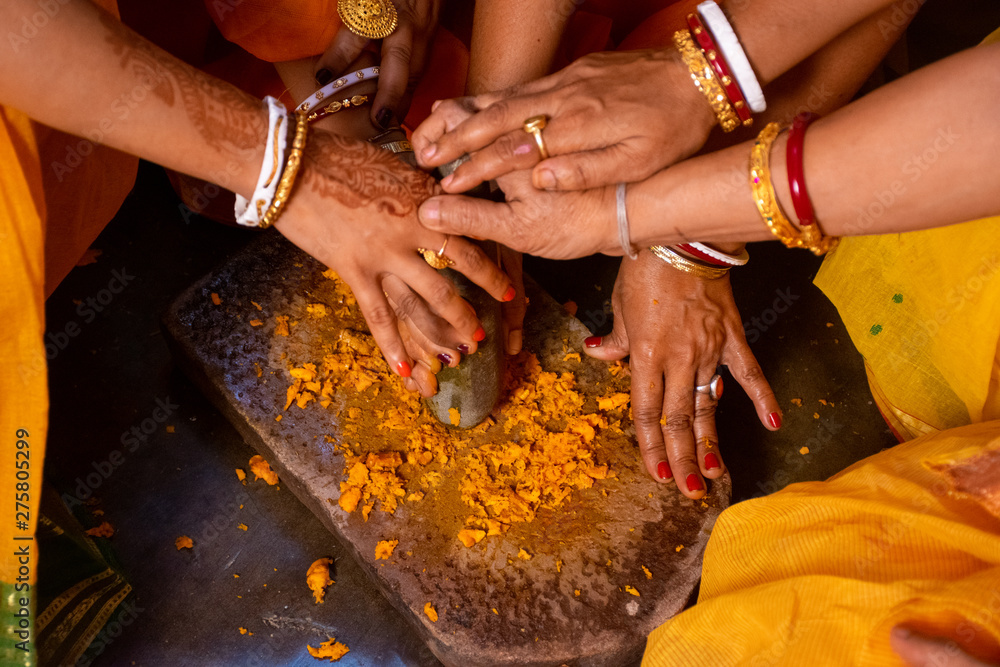 Group of Indian women holding a stone peace of mortar for making ...
