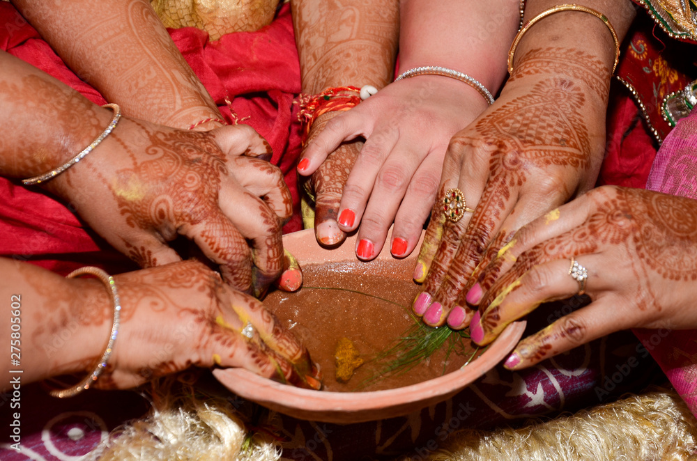Group of Indian women holding a stone peace of mortar for making ...