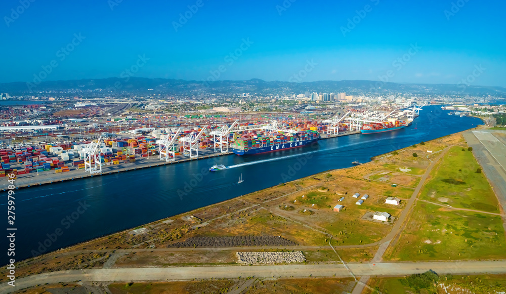 Oakland Harbor port terminal with cargo ship and shipping containers ...