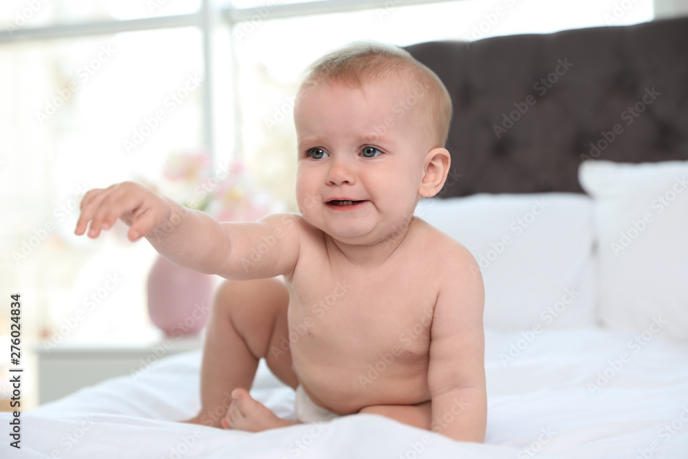Cute baby in diaper on bed at home Stock Photo | Adobe Stock
