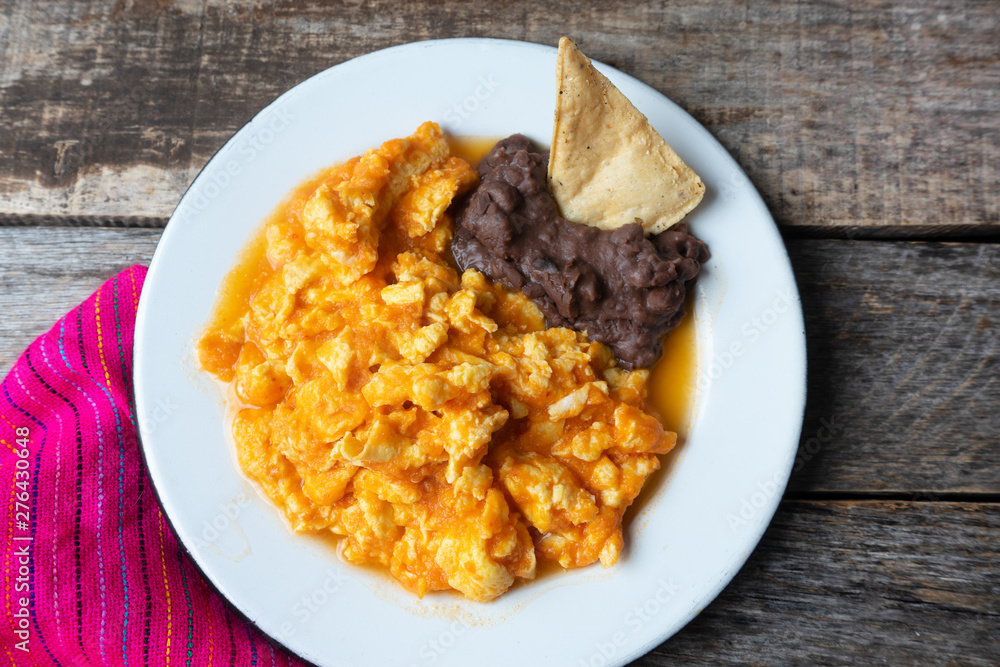 Mexican scrambled eggs in red sauce also called "al abañil" with beans ...