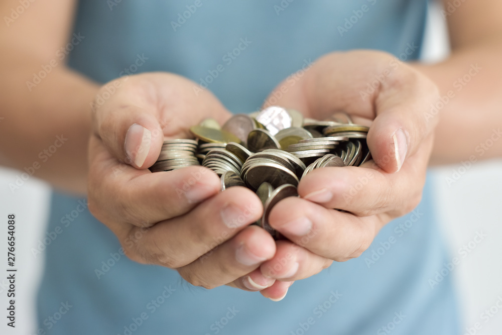 Coins in two hands. Concept money saving. Stock Photo | Adobe Stock