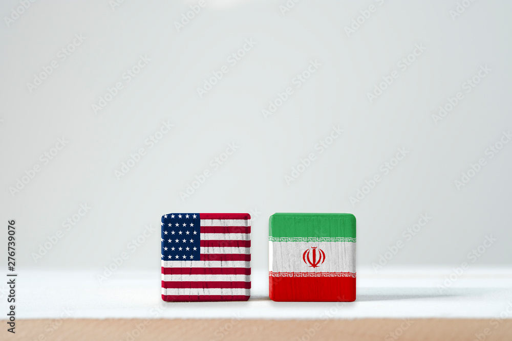USA flag and Iran flag print screen on wooden cubic with white ...