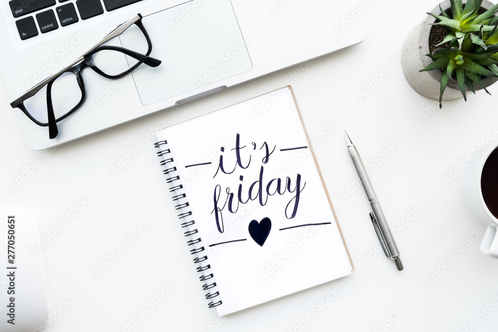 Notebook with it's friday text written on it on white office desktable ...