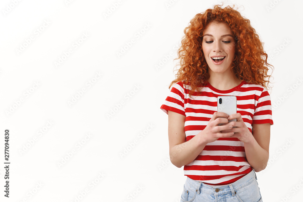 Redhead girl taking picture friend secretly recording video smartphone ...
