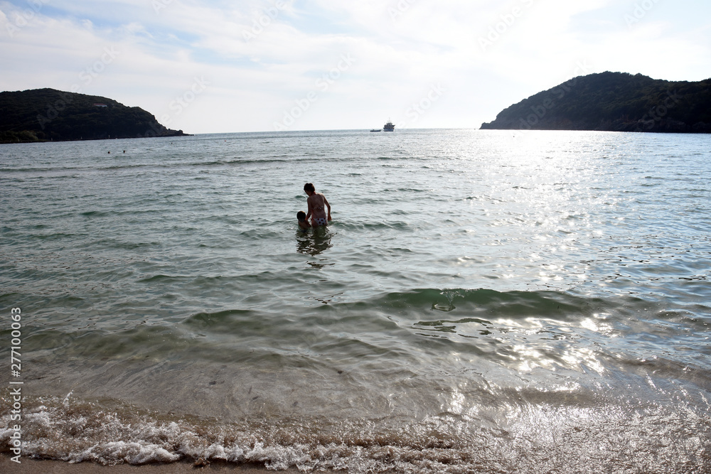 Mom and son in the sea. Mother and son in shallow water of Ammoudia ...