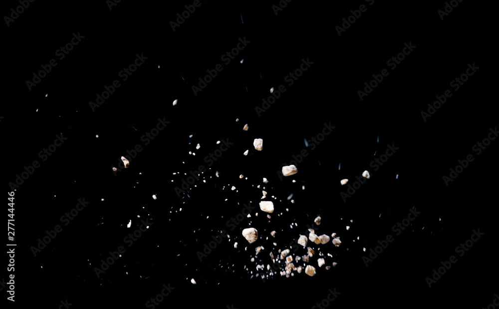 Break stone caused by explosion against black background の Stock フォト ...