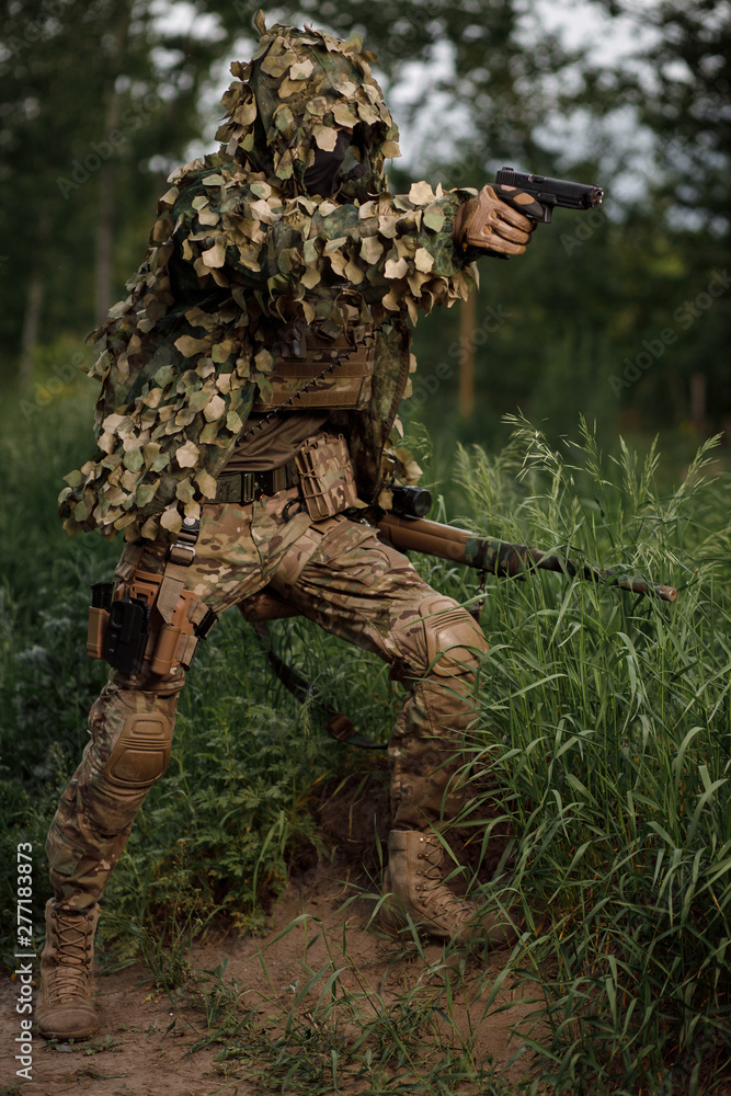 Стокове фото Airsoft soldier in full ammunition with rifle playing ...