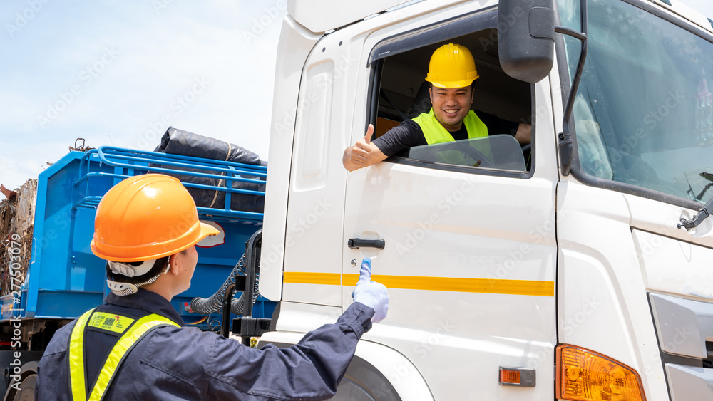 Foreman with safety hats and safety vest is carrying a car inspection ...