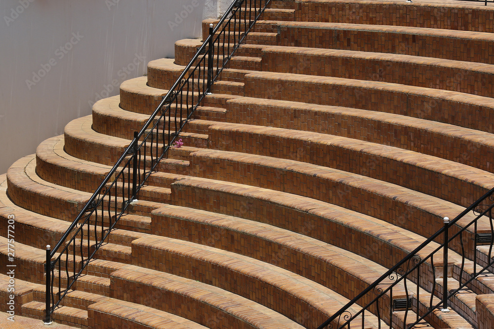 black metal railings and round, semicircular steps in the amphitheater ...