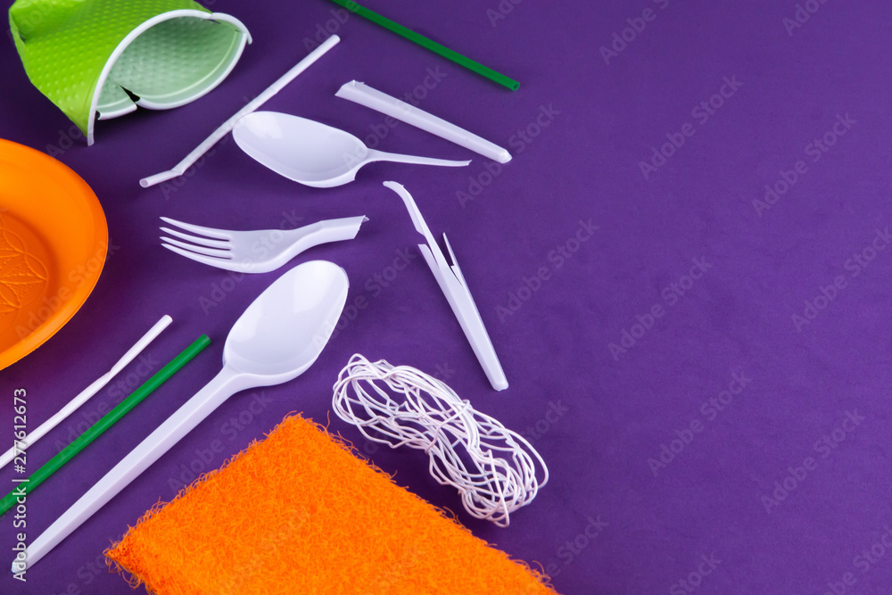 Single-use plastic objects, ecological pollution. Plastic waste. Orange ...