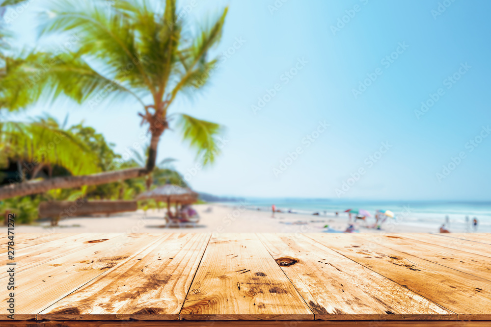Top of wood table with seascape, palm tree, calm sea and sky at ...