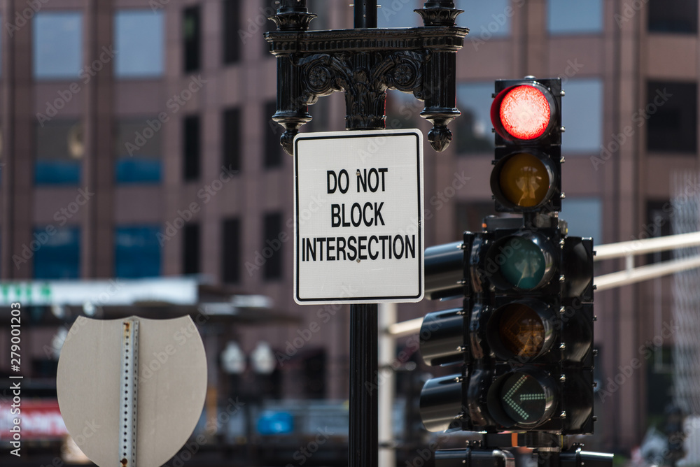 Signs and traffic lights help control traffic flow on downtown ...