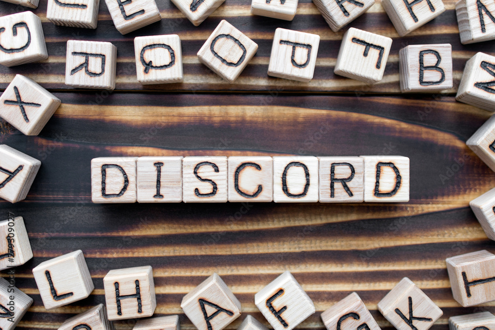 discord wooden cubes with letters, disagreement mistrust concept ...