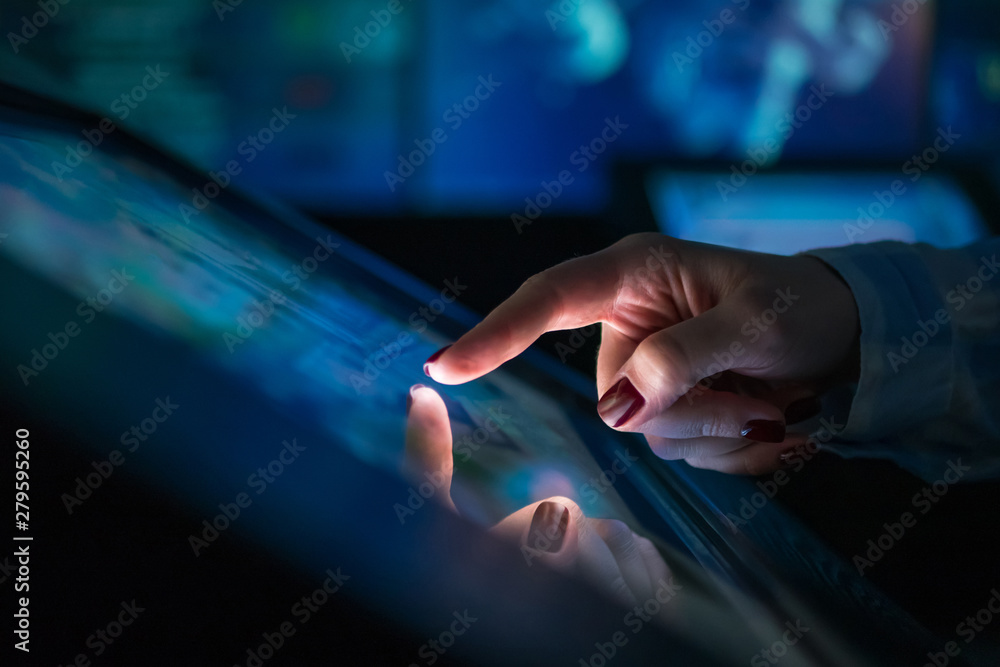 Woman using interactive touchscreen display of electronic multimedia ...