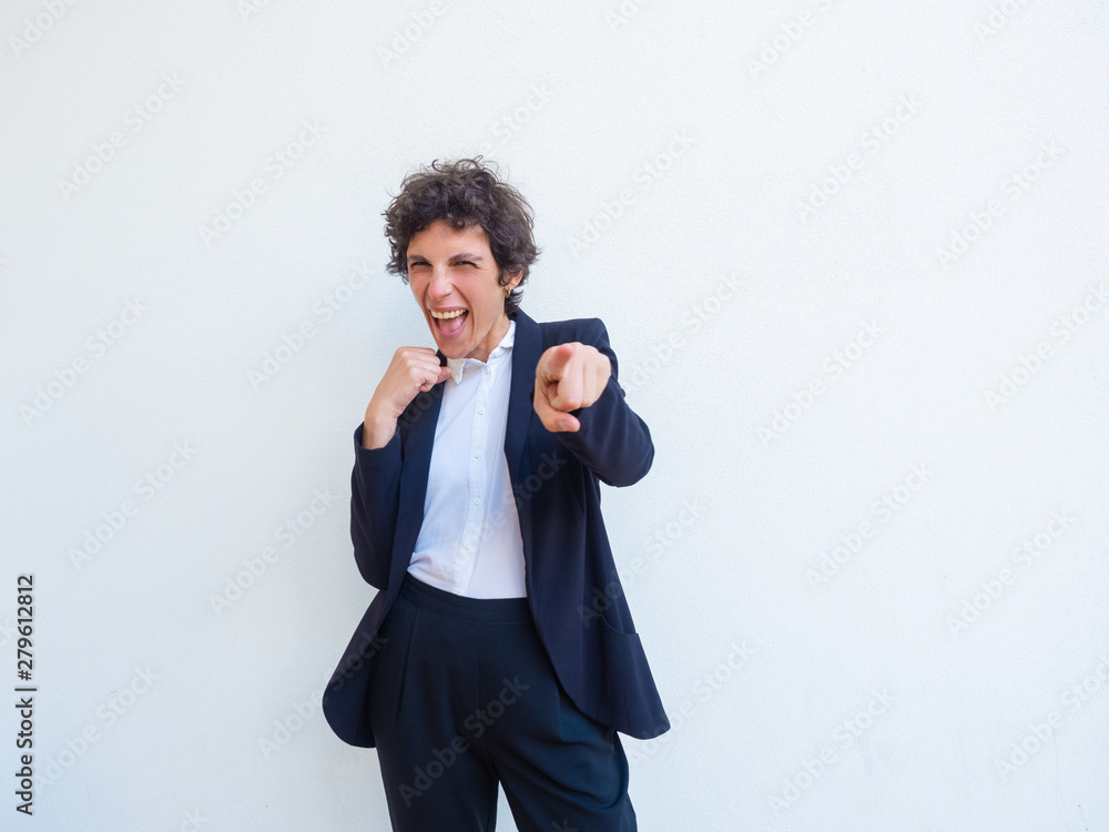 Joyful businesswoman teasing and laughing at camera. Middle aged woman ...