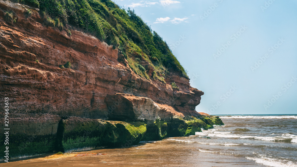 sandy beach with red sand and rock in Exmouth ,Devon, UK. Jurassic ...