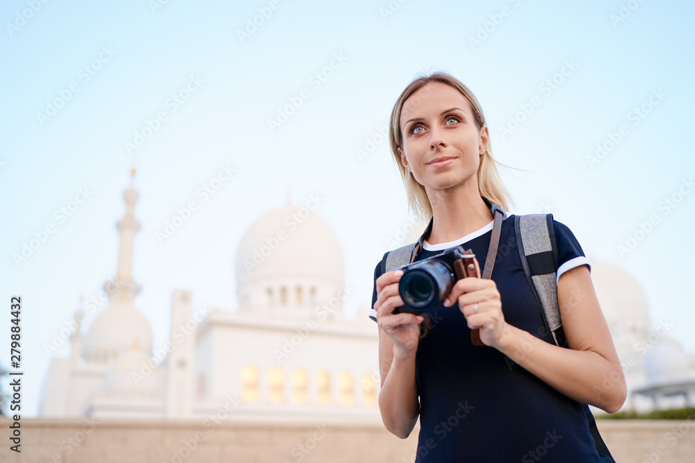 Traveling by Unated Arabic Emirates. Pretty Young Woman with camera ...