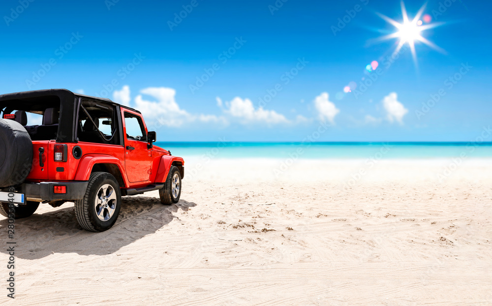 A red jeep on sandy beach and beuatiful blue sunny sky view in summer ...
