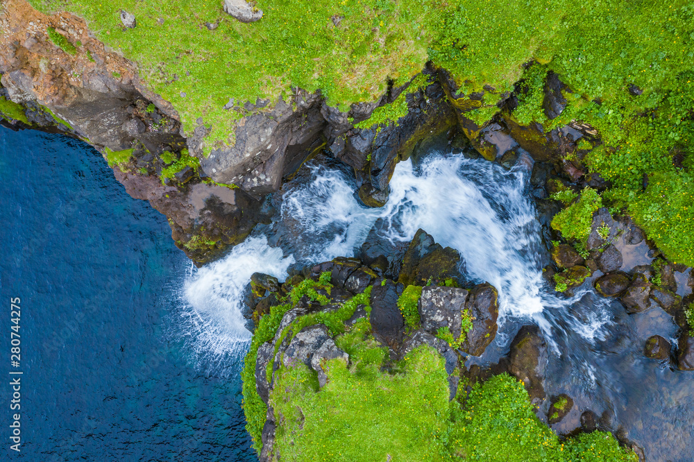 Aerial view of Mulafossur waterfall in Gasadalur village in Faroe ...