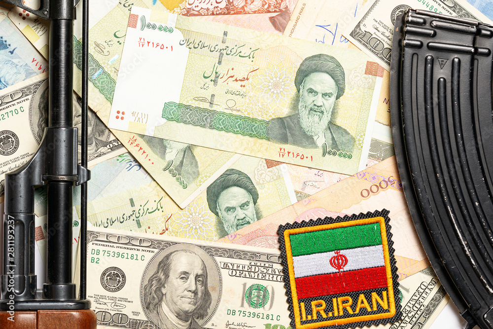 Soviet automaton AK 47 against the backdrop of Iranian money depicting ...