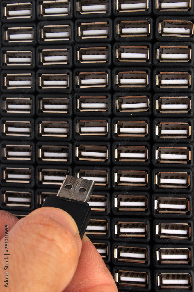 Man inserts USB flash drive in one of many sockets Stock Photo | Adobe ...