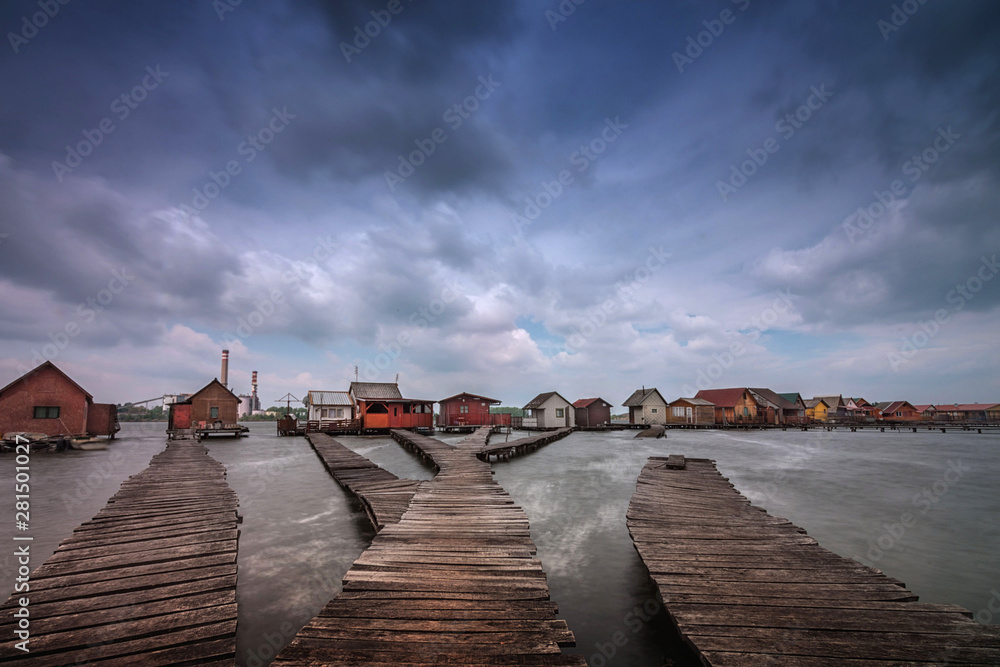 Bokod floating village with piers and fishing wooden cottages, in one ...