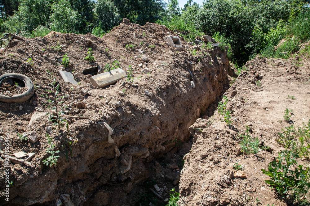 Trench dug by a tractor. Pit for draining the water. Ditch to discharge ...
