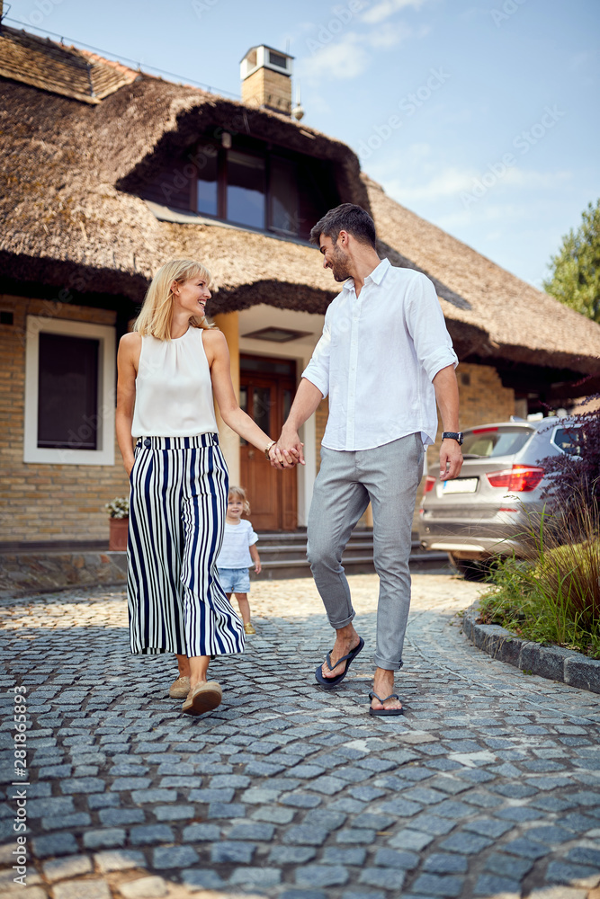 Happy parents with daughter on weekend walking Stock Photo | Adobe Stock