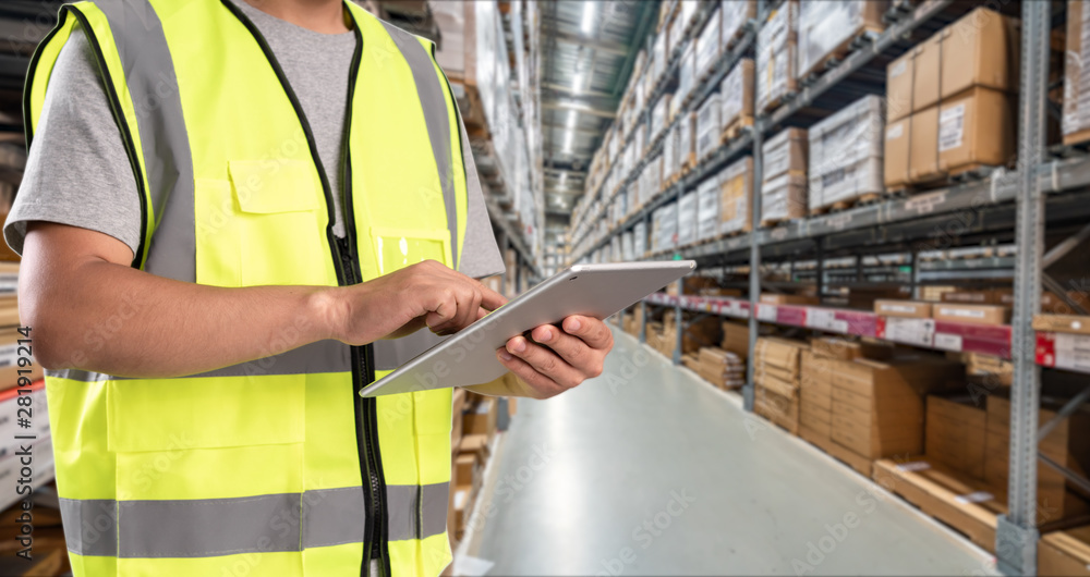 worker hand holding pad for check order pick time in smart factory ...