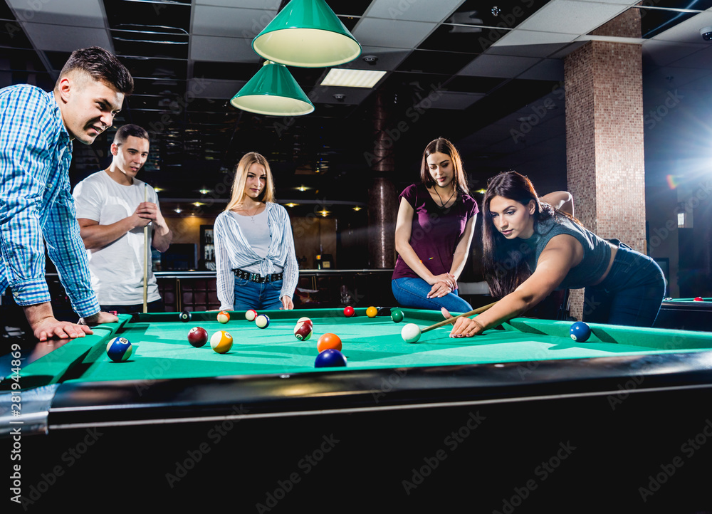 Group of young cheerful friends playing billiards. Stock Photo | Adobe ...