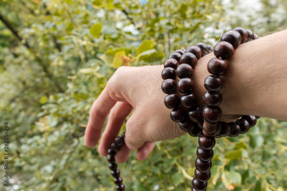 Foto de Stock rosary of sandalwood beads wrapped around arm and fingers ...