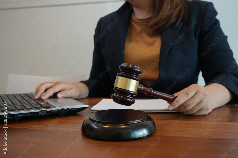 Legal counsel presents to the client a signed contract with gavel and ...