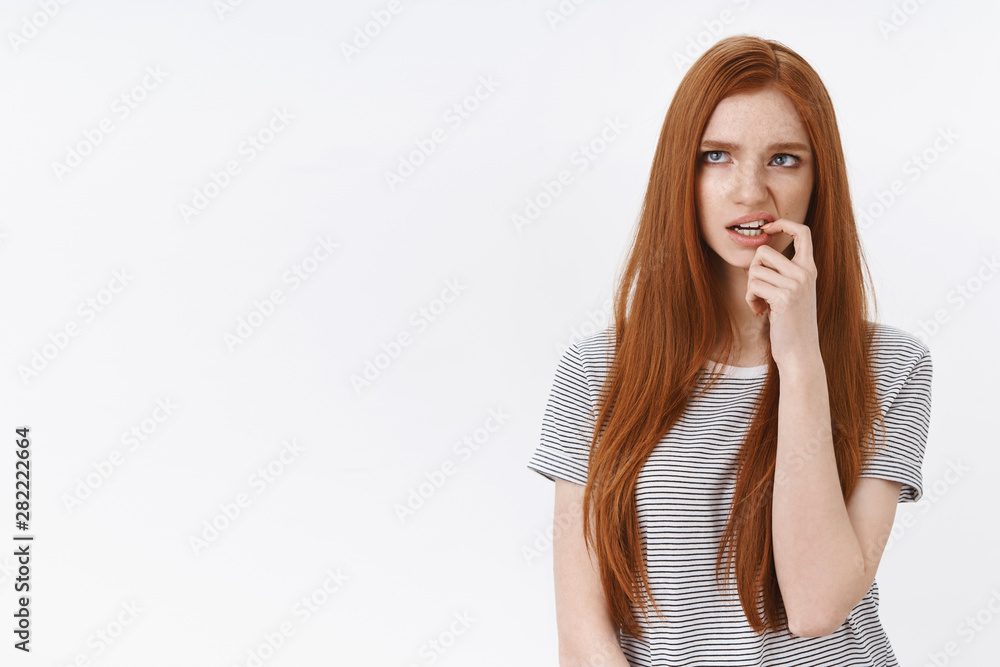 Waist-up shot hesitant redhead cute girl blue eyes have doubts standing ...