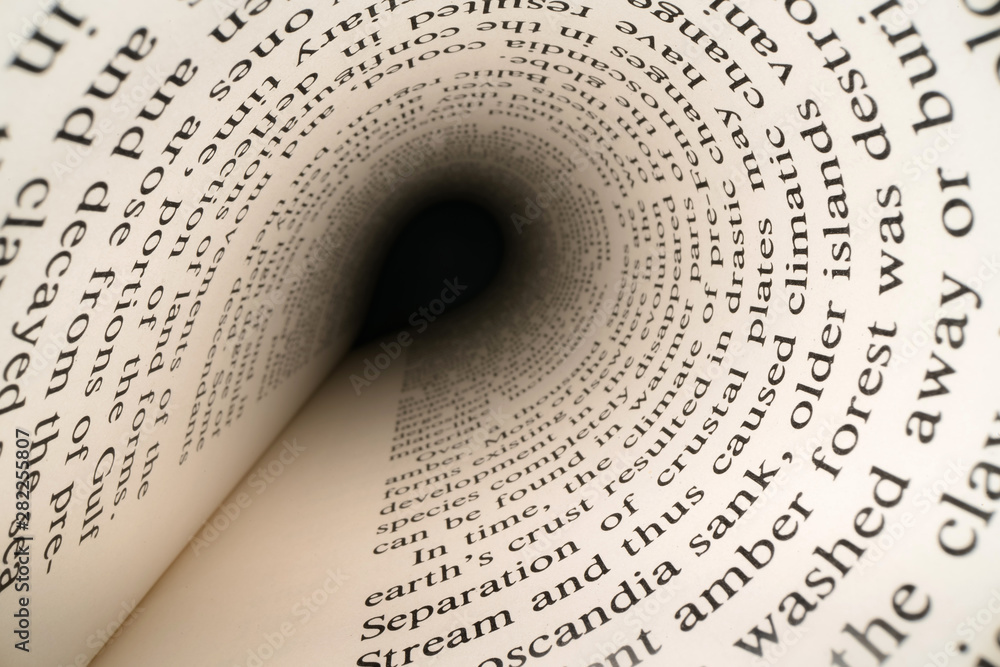 Inside the book concept. Latin letters and words on an tunnel shaped ...