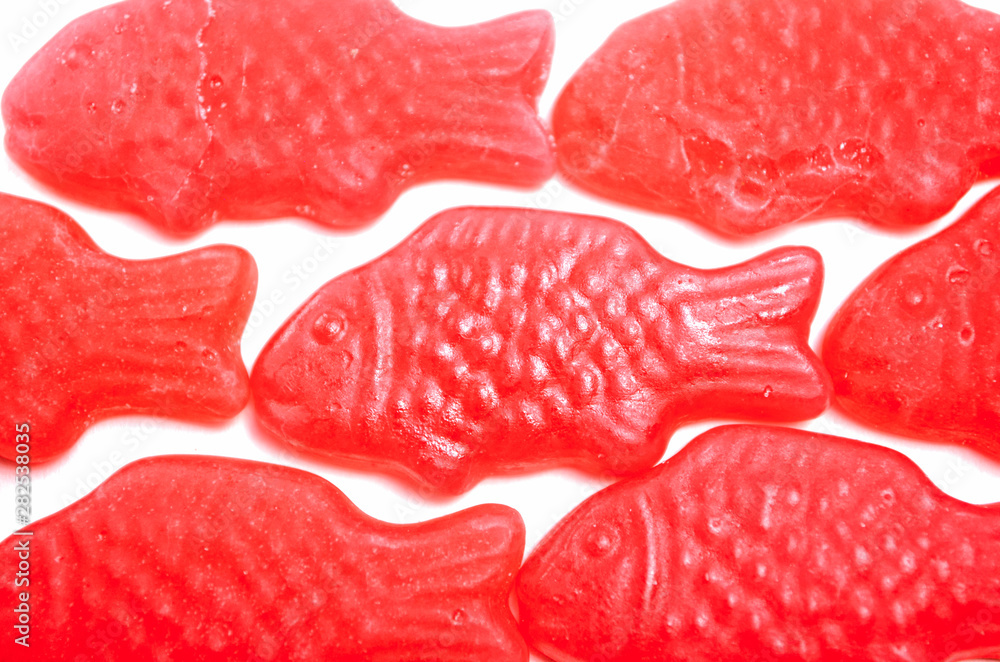 Isolated red fish-shaped jelly. Jellyfisk with strawberry flavor ...