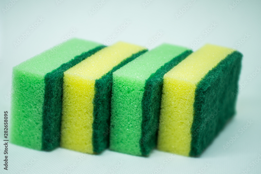Different color sponges for washing dishes, staggered on top of each ...