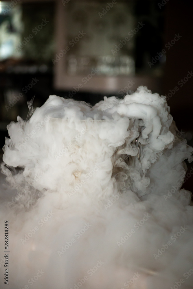 dry ice evaporates and gives a thick fog Stock Photo | Adobe Stock