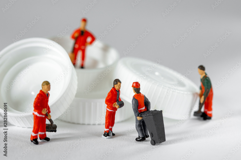 Miniature Garbage man cleaning and sorting a pile of plastic bottle ...