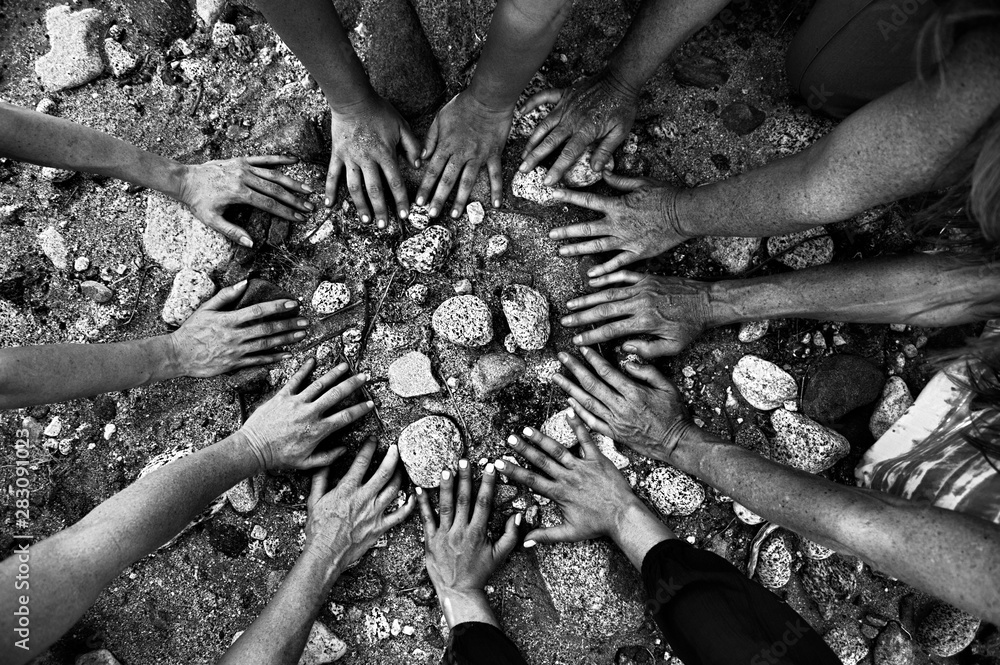 Women's gathering hands all coming together in a circle in nature ...