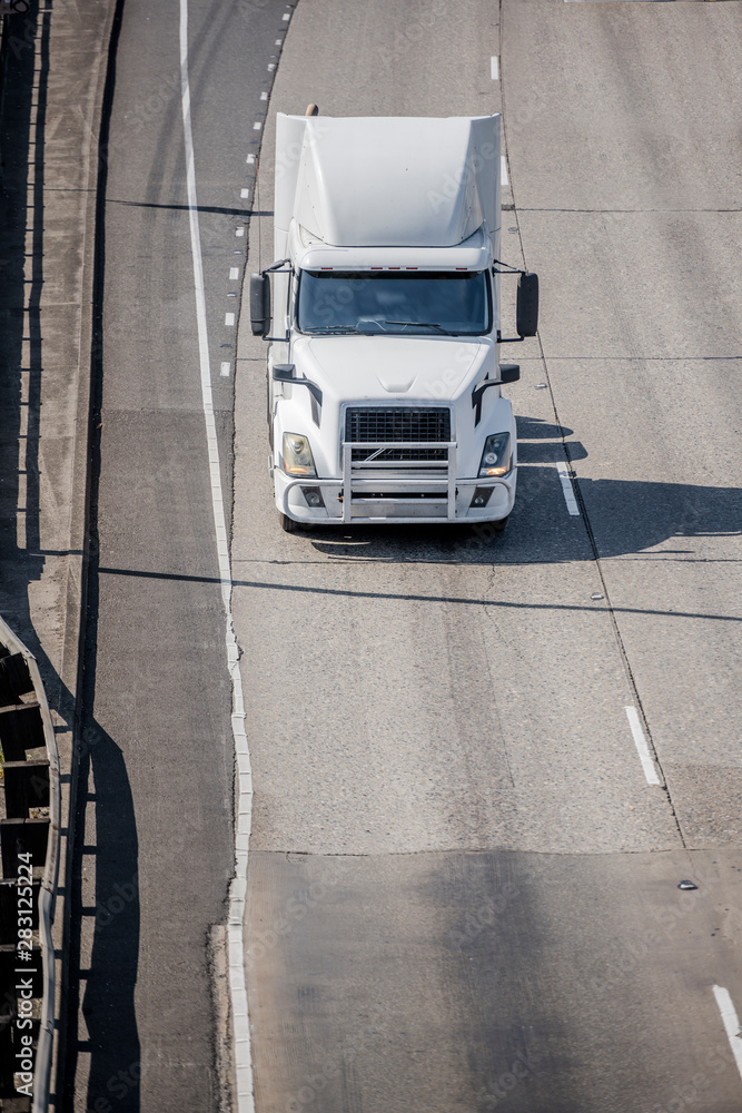 Big rig white bonnet semi truck tractor driving on the road to ...