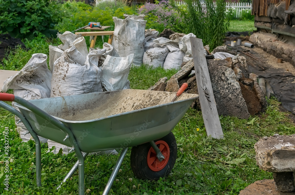 construction waste, transport trolley and other tools are located on ...