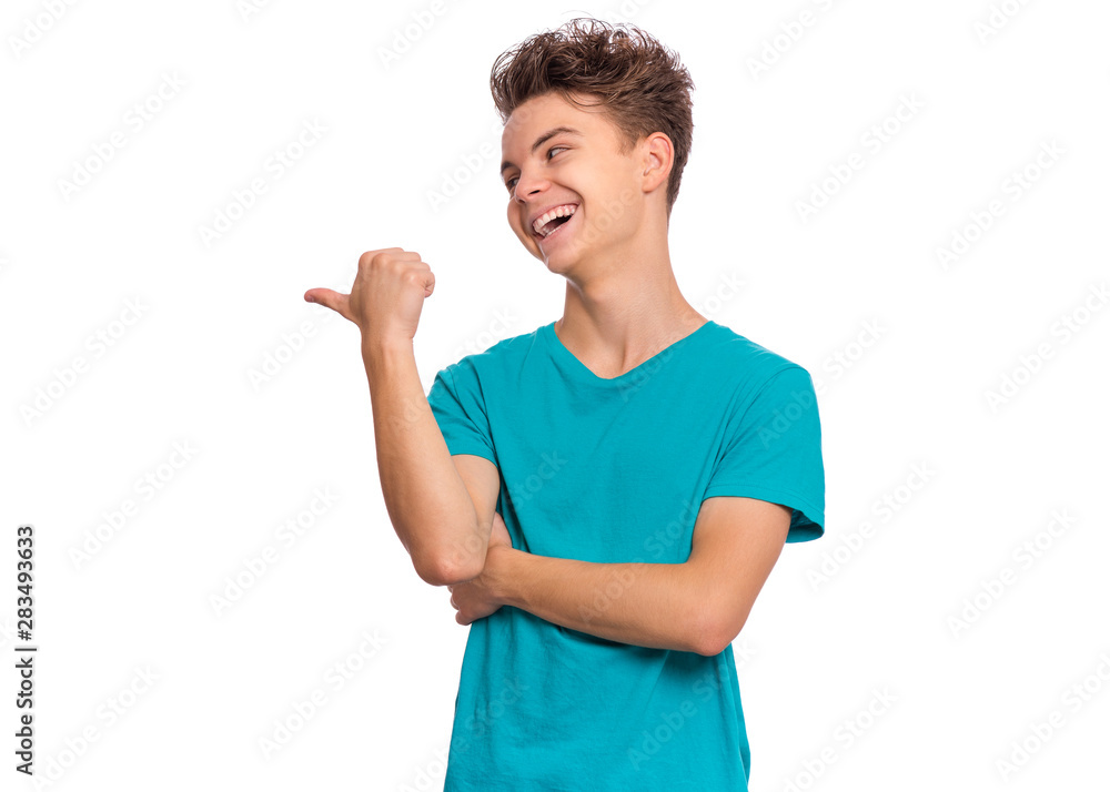 Portrait of teen boy pointing to back behind with hand and thumb up ...