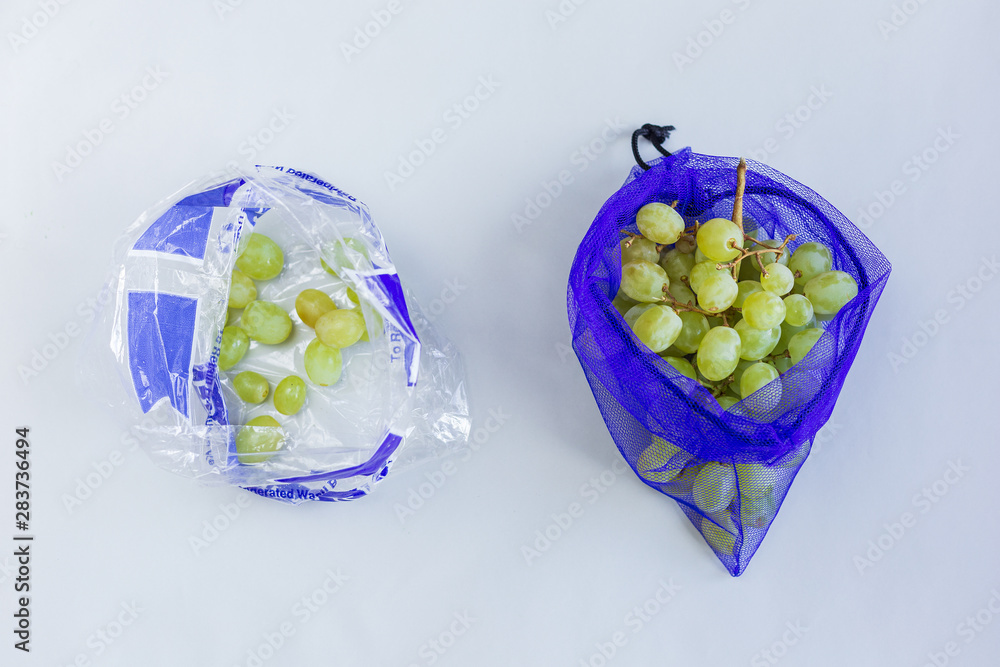 Eco friendly reusable blue bag with grapes vs plastic bag for shopping ...
