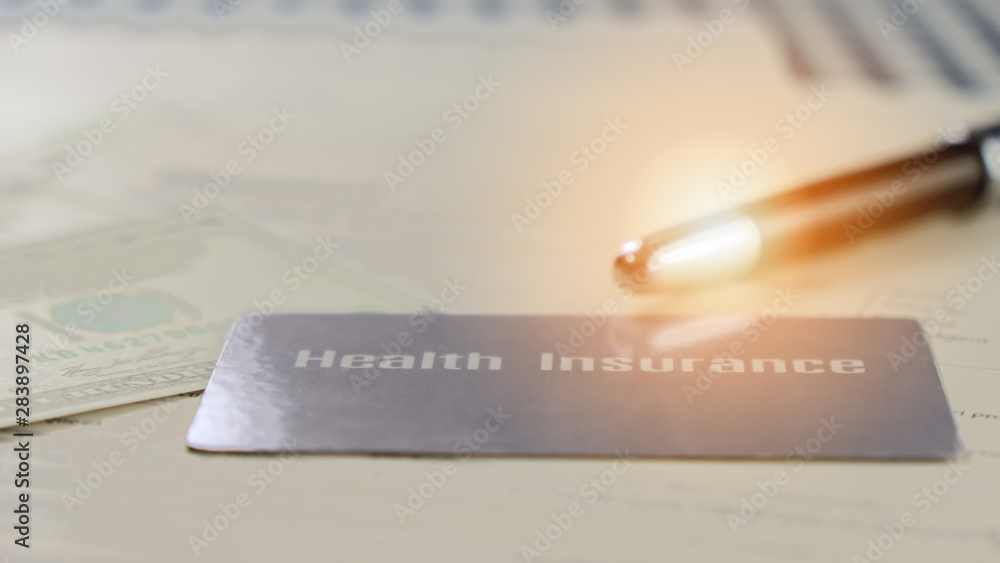 health insurance card and bank note and pen on background of general ...